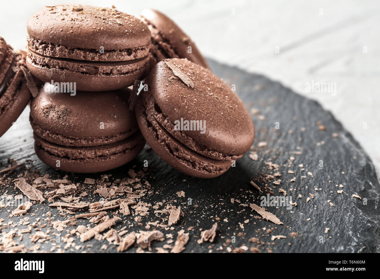 Slate plate with delicious chocolate macarons, closeup Stock Photo - Alamy