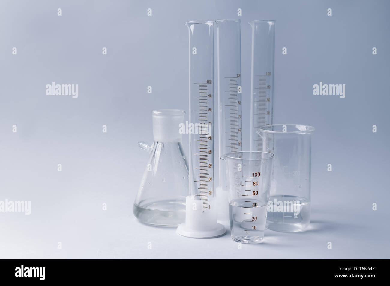 Different laboratory glassware on grey background Stock Photo - Alamy