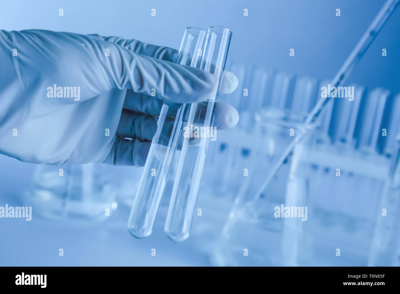 Scientist holding test tubes with liquid in laboratory Stock Photo - Alamy