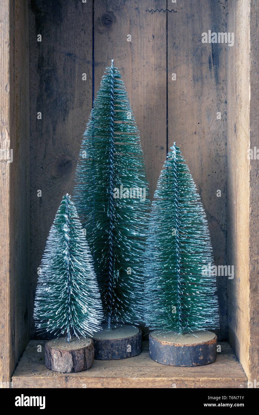 three Christmas tree objects in a wooden box Stock Photo - Alamy