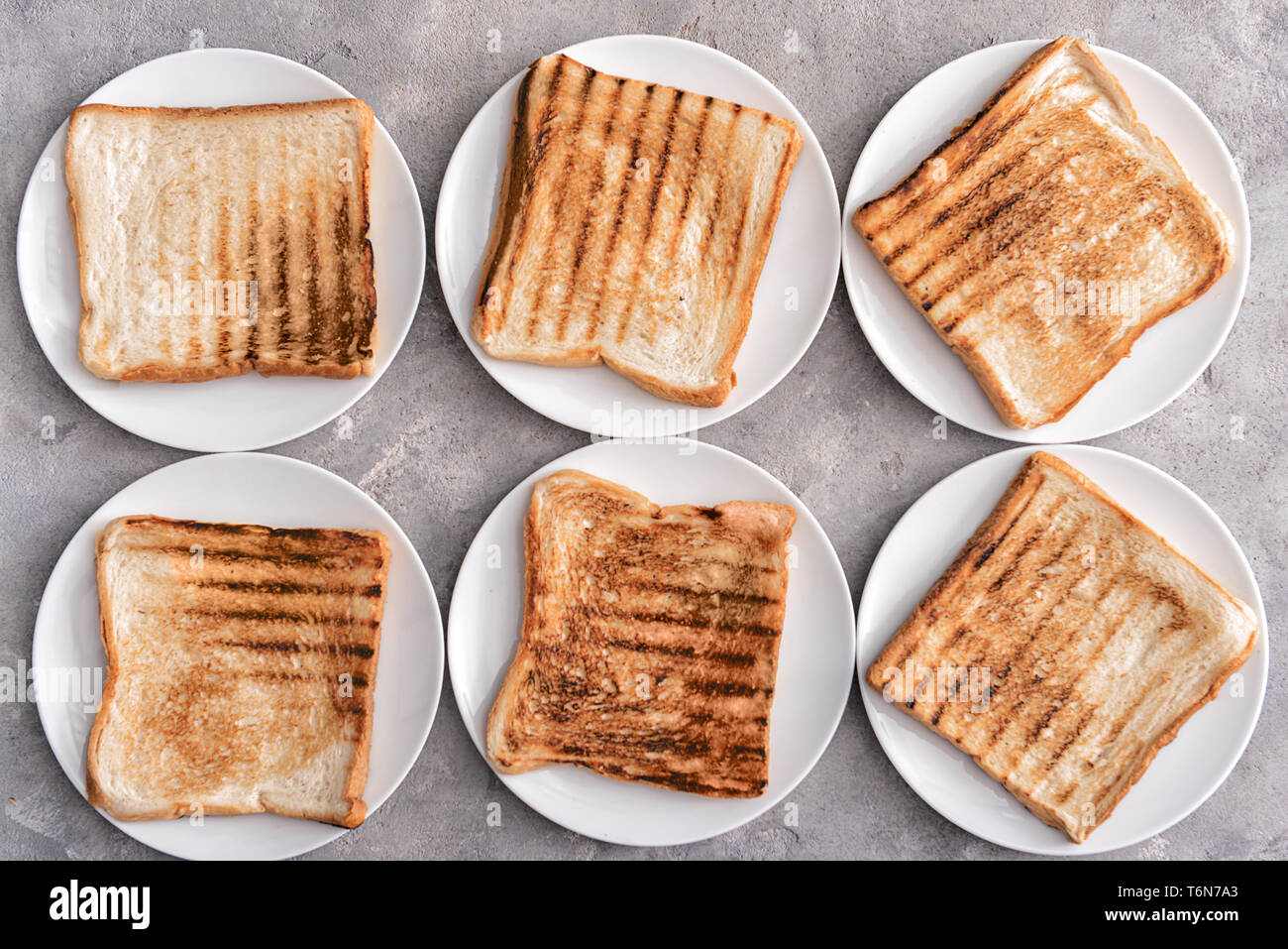 Flat lay composition with tasty toasted bread on table Stock Photo - Alamy