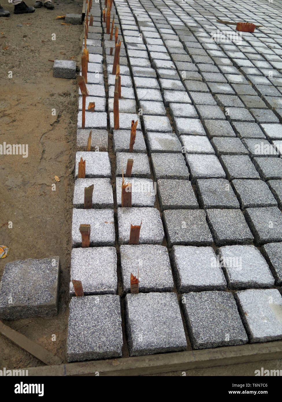 Square paving stones awaiting grouting in village street in Andalusia ...