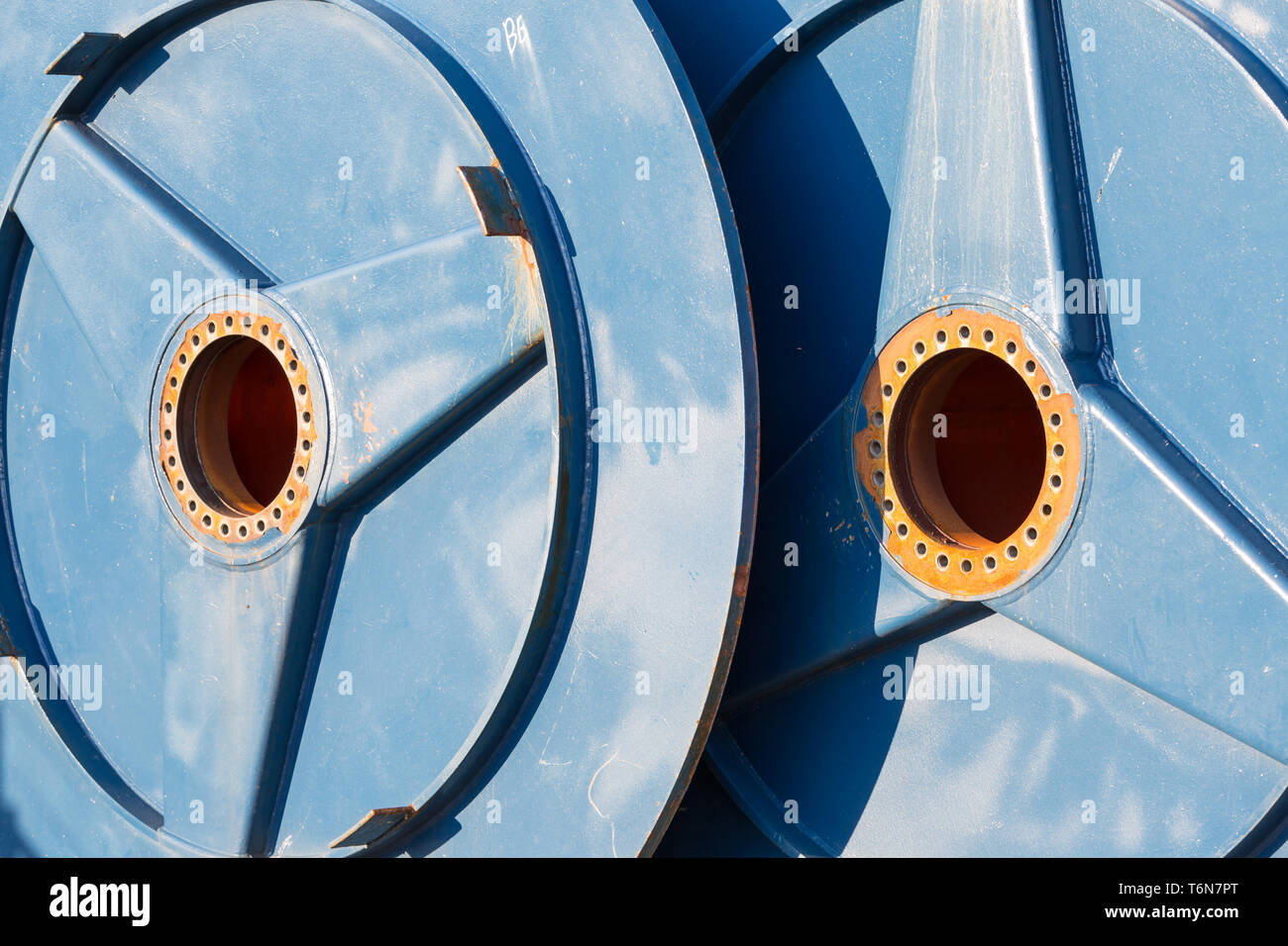 Two big metal spools with hole for drive shaft Stock Photo - Alamy