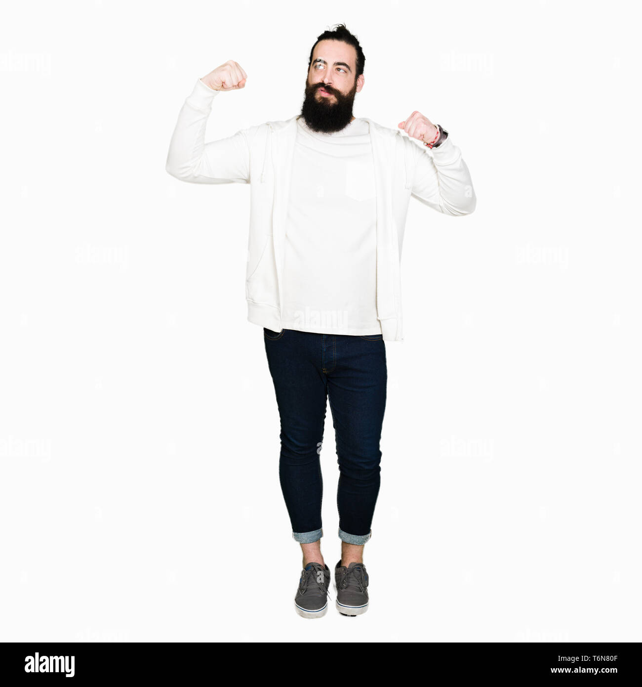 Young man with long hair and beard wearing sporty sweatshirt showing ...