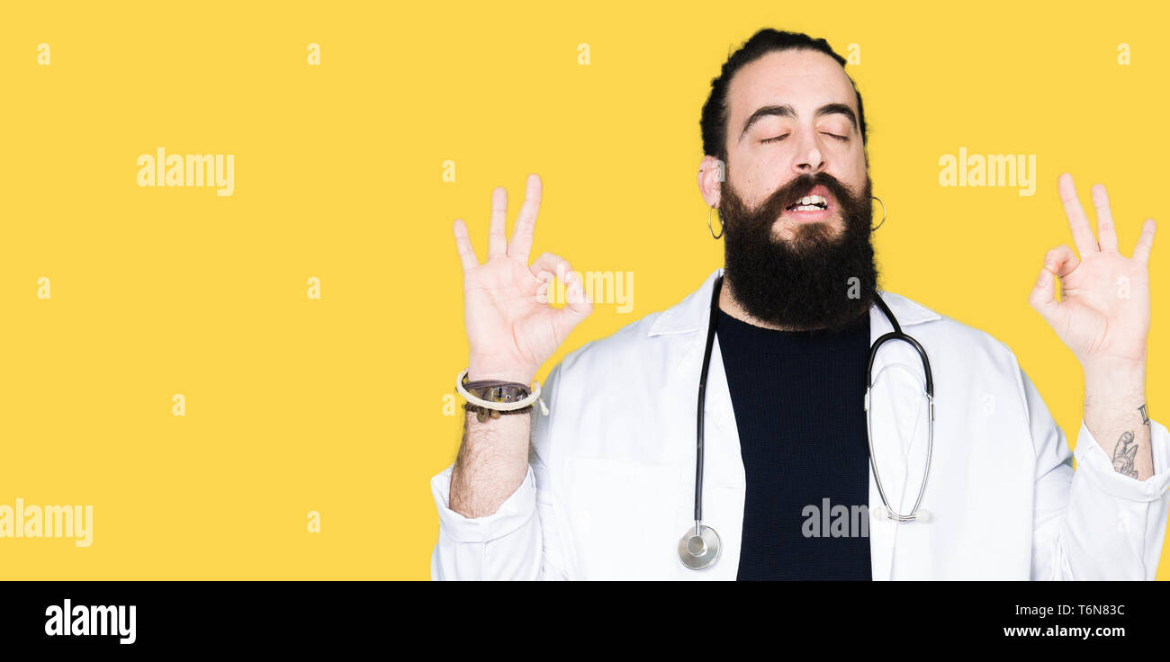 Doctor with long hair wearing medical coat and stethoscope relax and ...