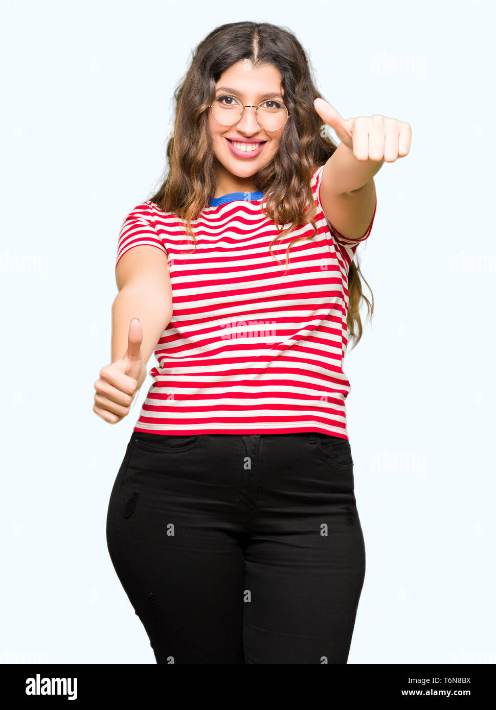 Young beautiful woman wearing glasses approving doing positive gesture ...