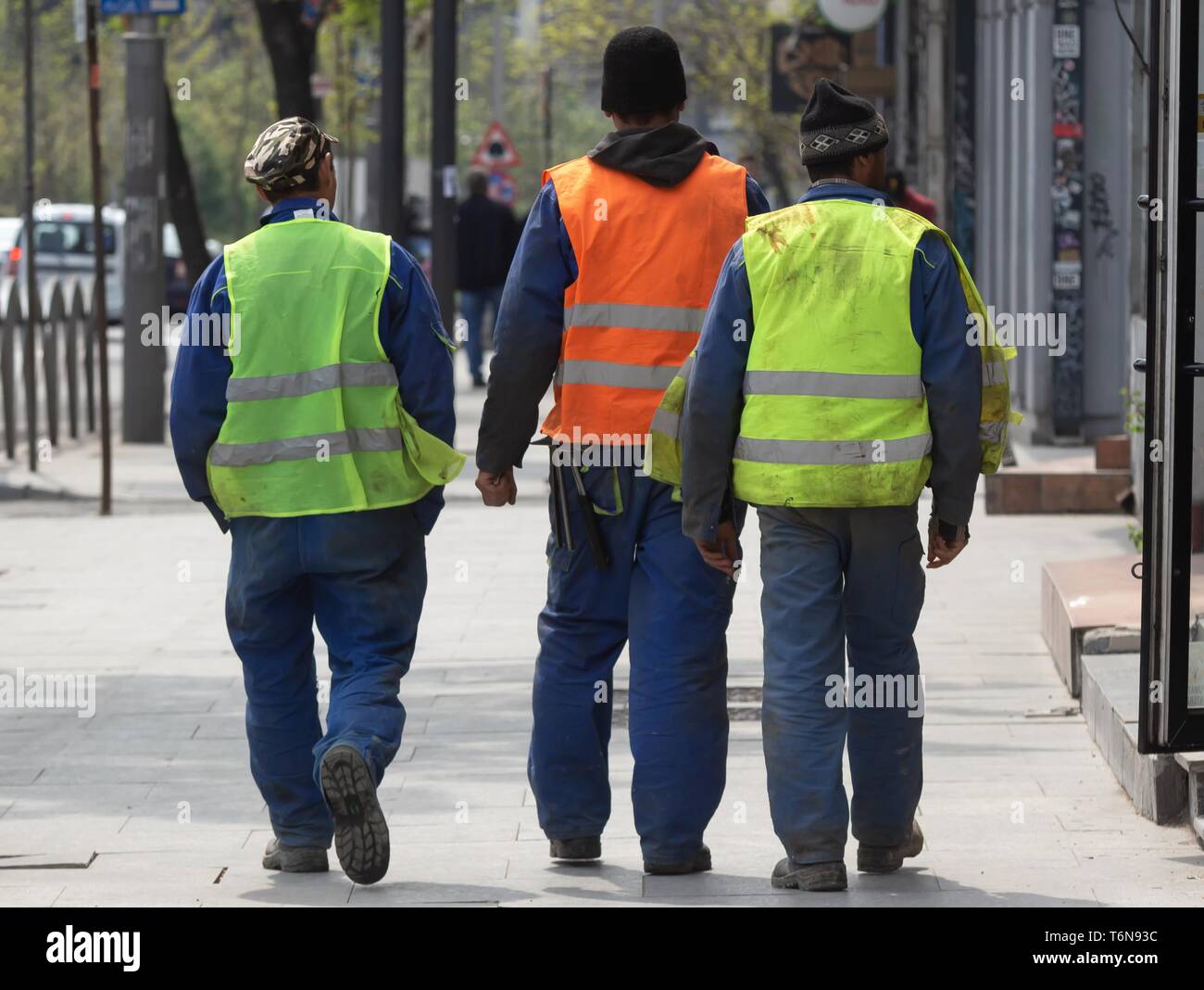 Bucharest, Romania - April 22, 2019: Three construction workers dressed ...