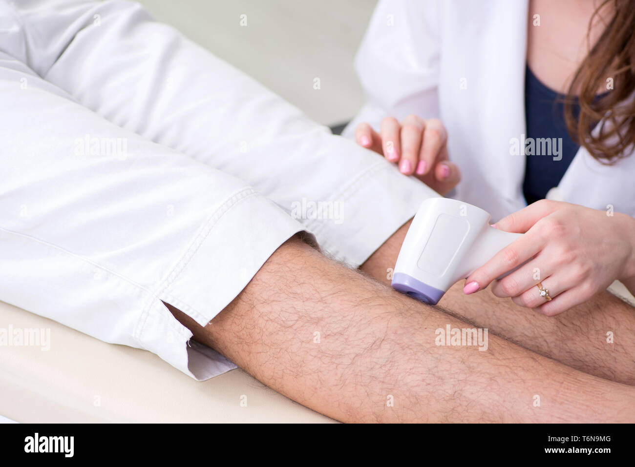 The young man visiting doctor for epilation Stock Photo - Alamy