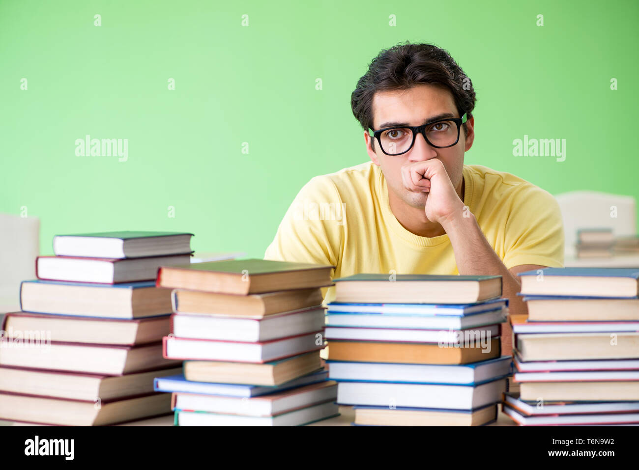 The student with too many books to read before exam Stock Photo - Alamy