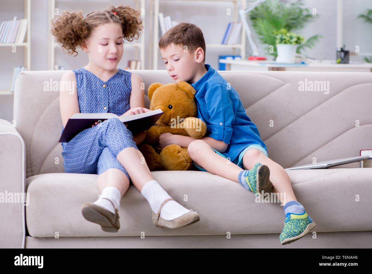 The two kids reading books at home Stock Photo - Alamy