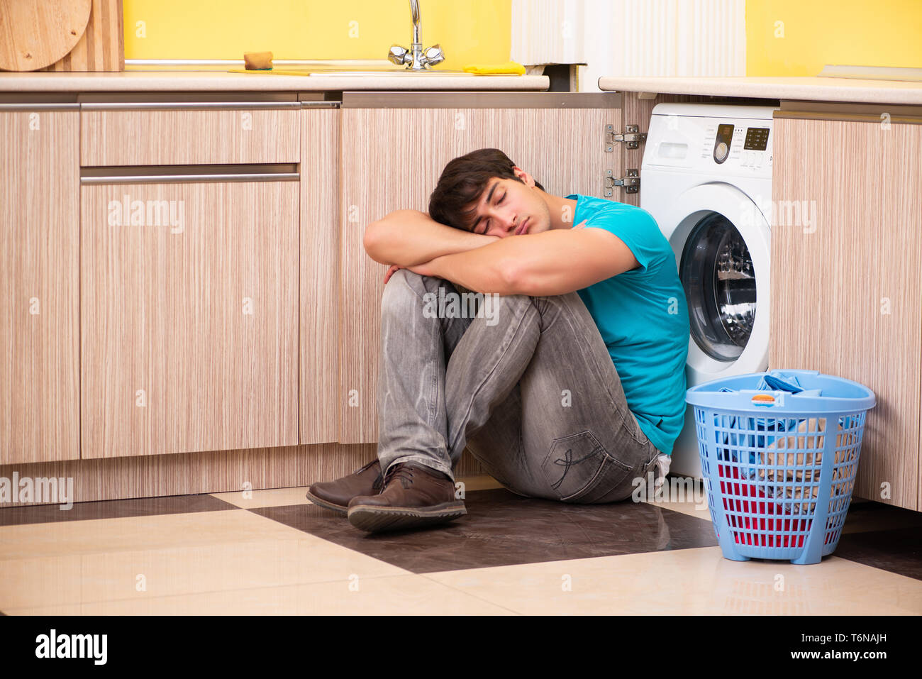 The young husband man doing laundry at home Stock Photo - Alamy