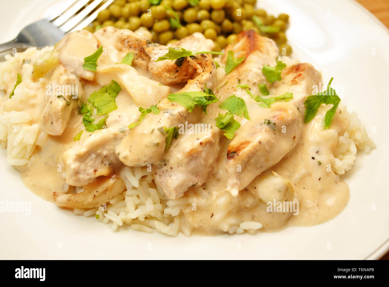 Pork with White Sauce Over White Rice Stock Photo - Alamy