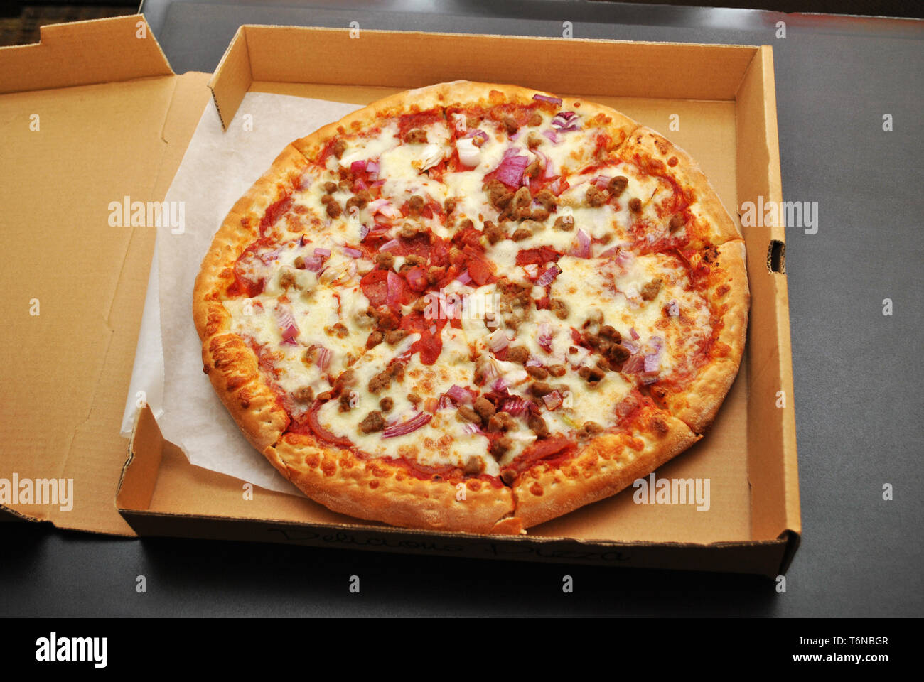 Meat Pizza with Onions in a Takeout Box Stock Photo - Alamy