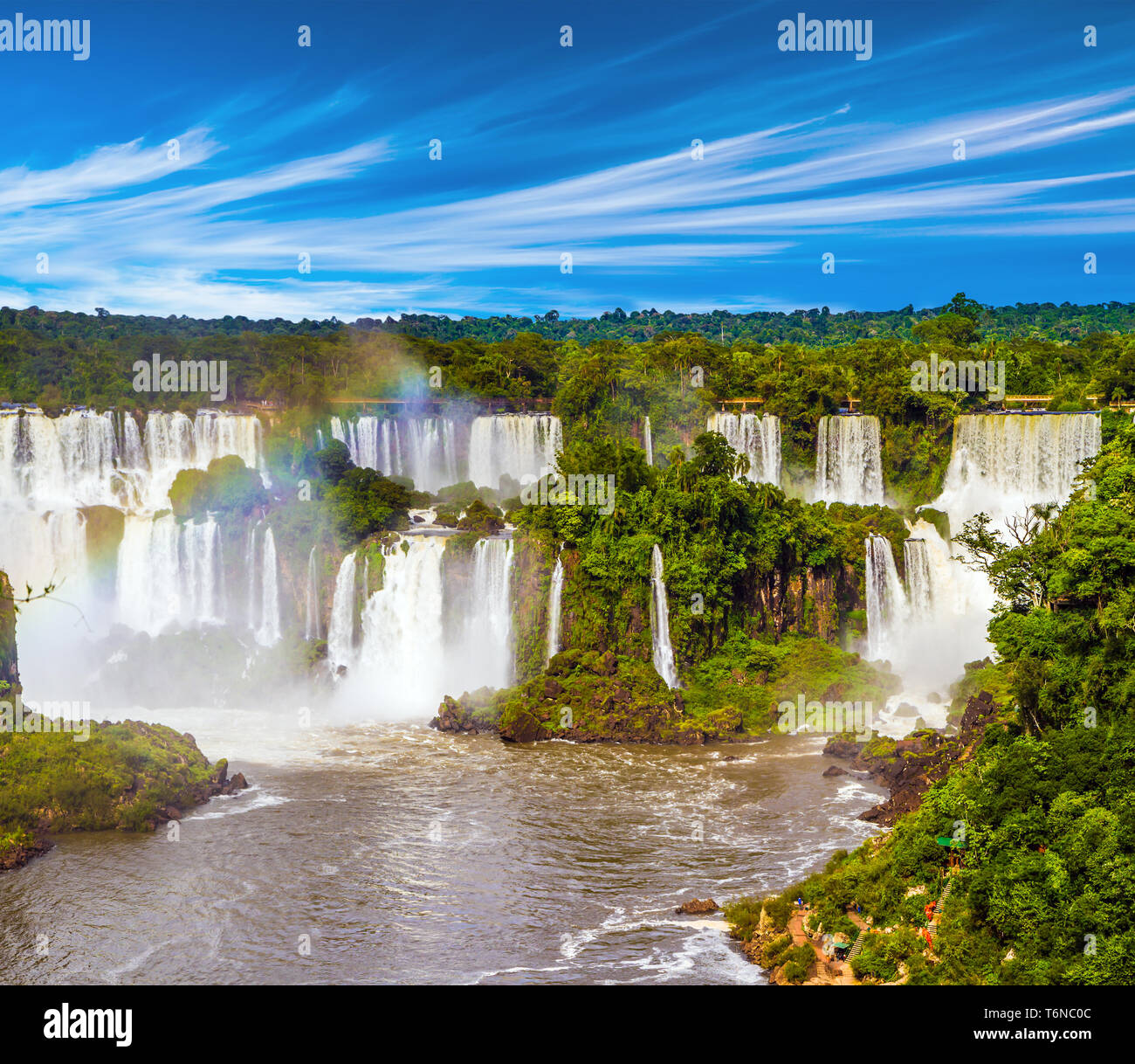 Powerful waterfall creates rainbow Stock Photo - Alamy