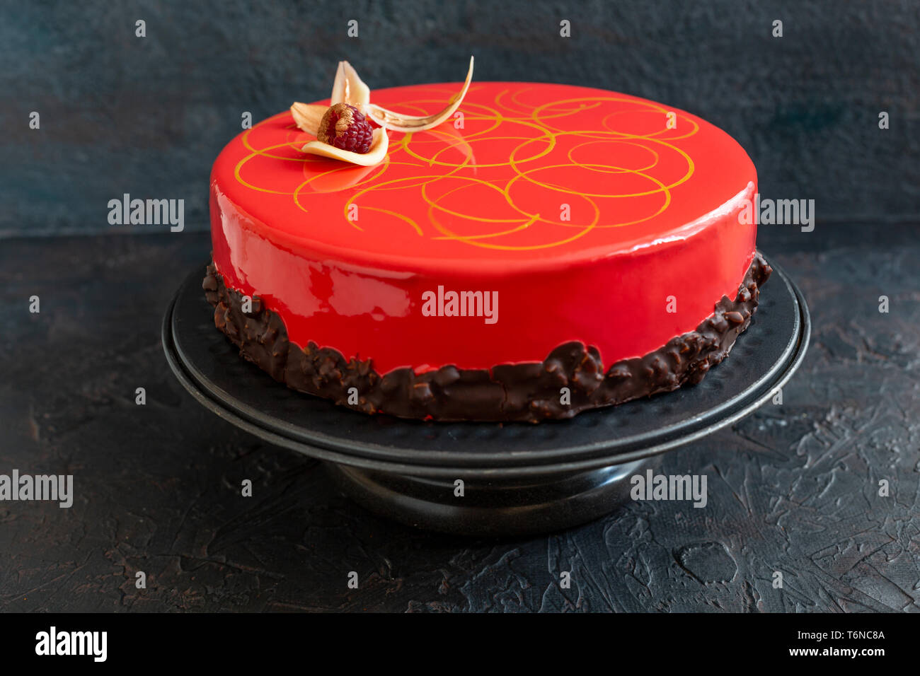 Stand with modern mousse cake with red frosting Stock Photo - Alamy