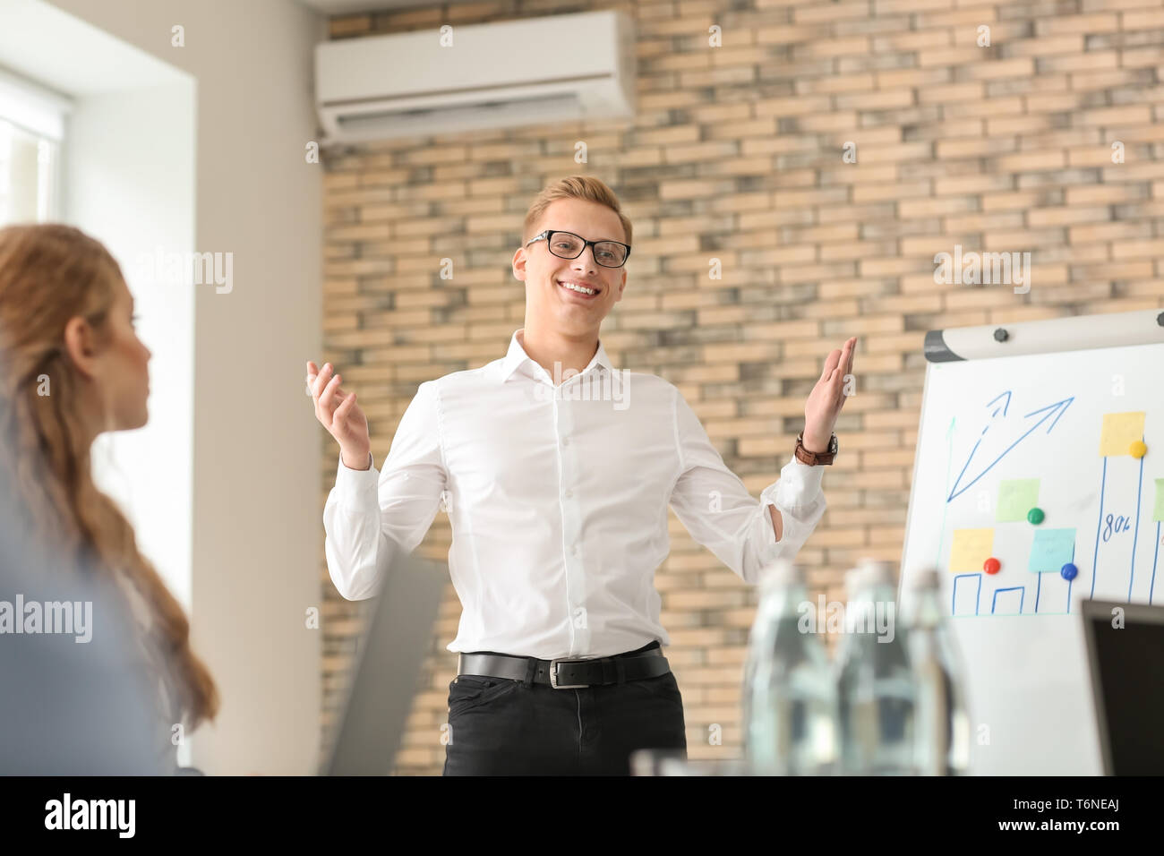 Young man giving presentation at business meeting Stock Photo - Alamy