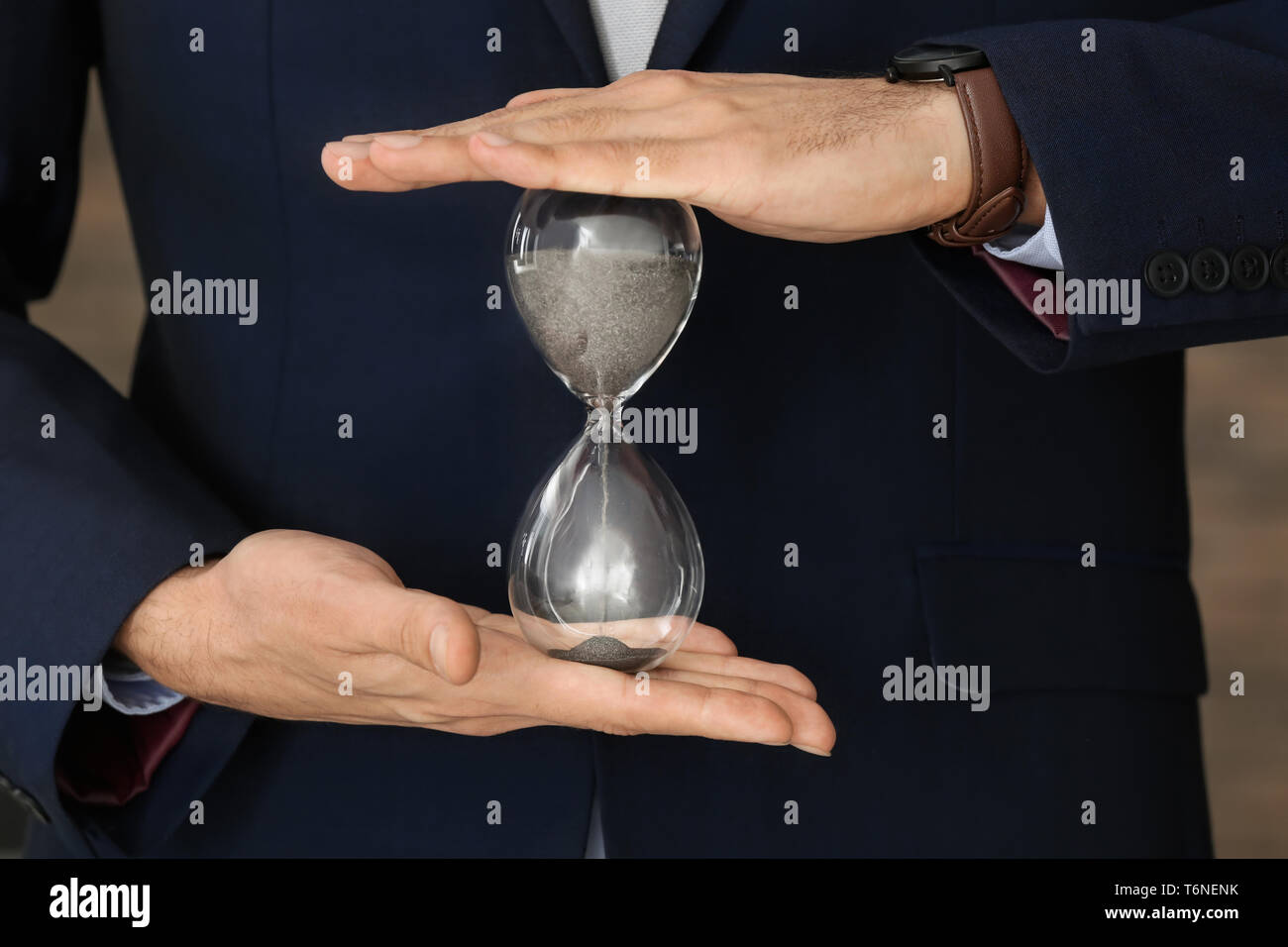 Man holding hourglass closeup hi-res stock photography and images - Alamy