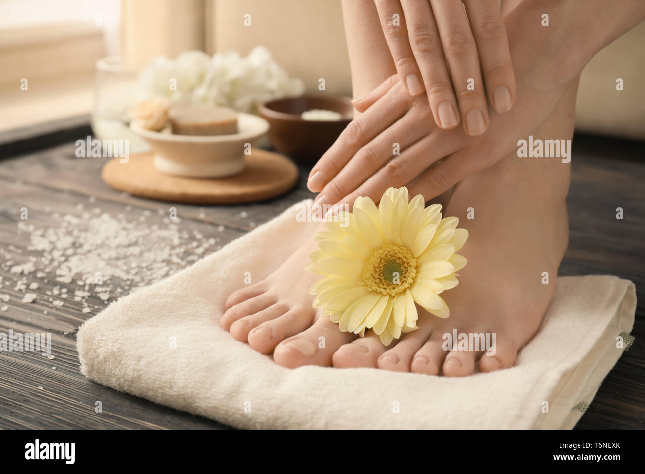 Young woman with beautiful pedicure and manicure after treatment in spa ...