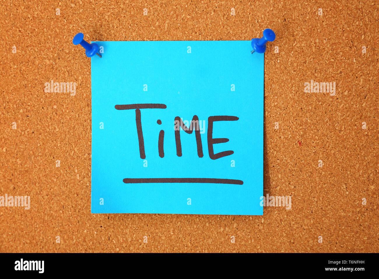 Sticker paper with word TIME on cork background Stock Photo - Alamy