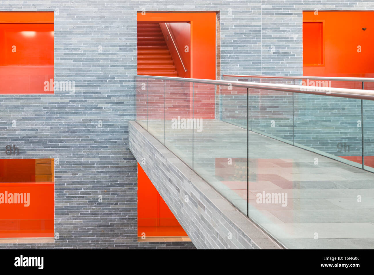 Catwalk modern building with several floors and orange painted passages ...