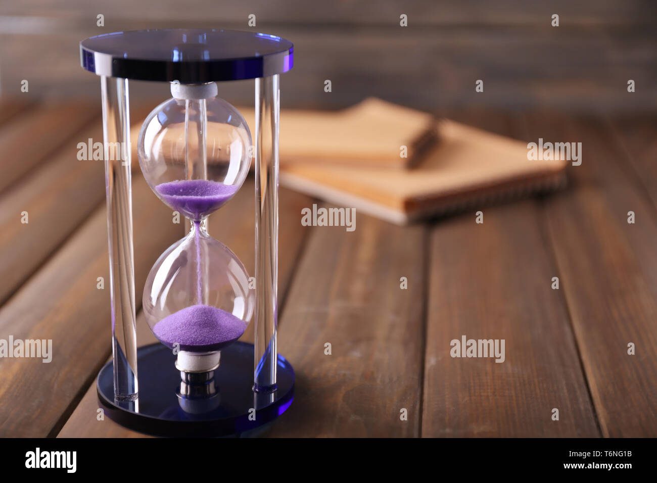 Stylish hourglass on table. Time management concept Stock Photo - Alamy