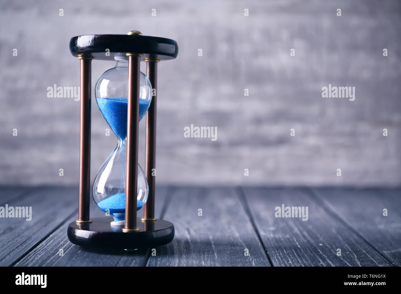 Stylish hourglass on table. Time management concept Stock Photo - Alamy