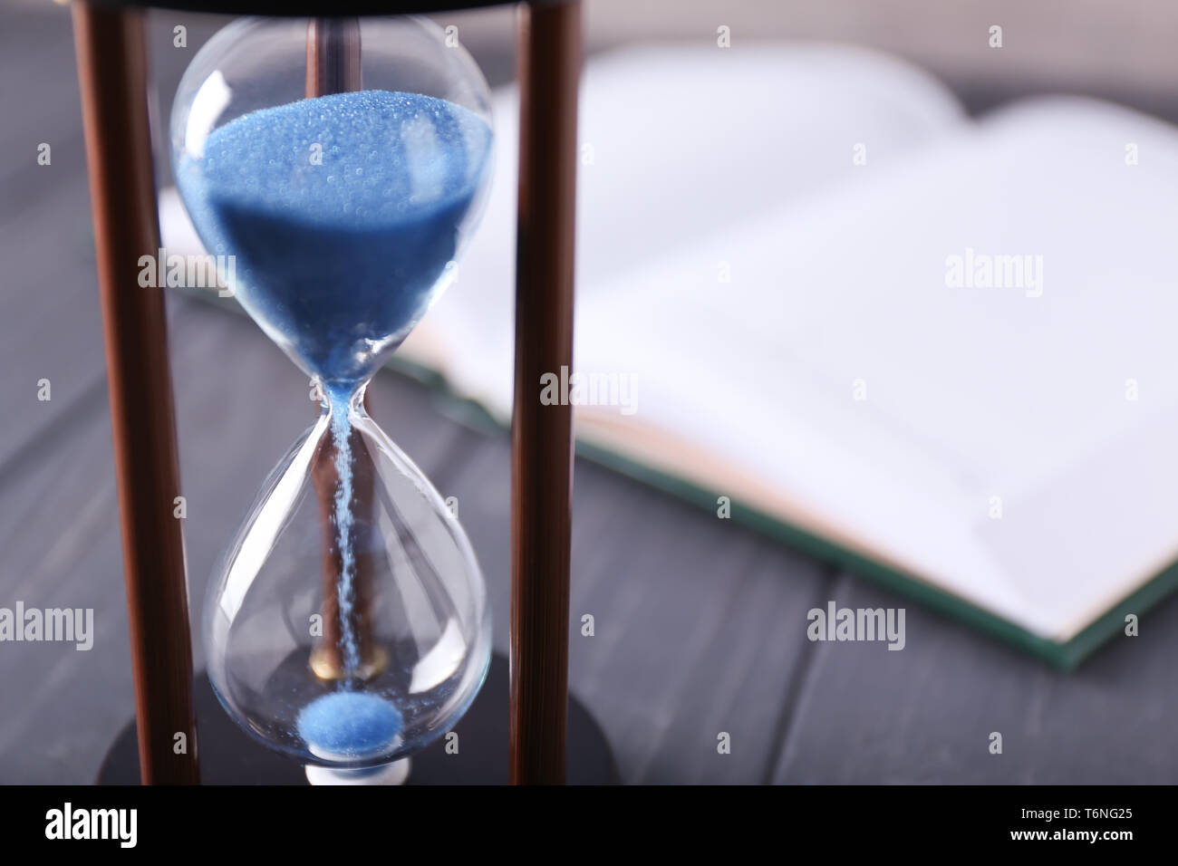 Stylish hourglass on table. Time management concept Stock Photo - Alamy