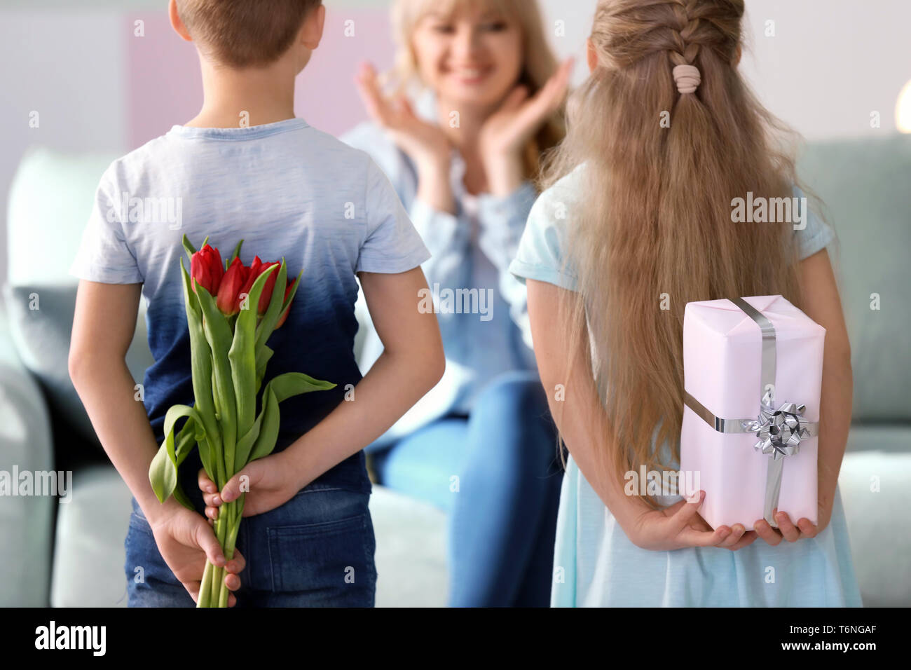 Boy and girl hiding behind hands hi-res stock photography and images ...