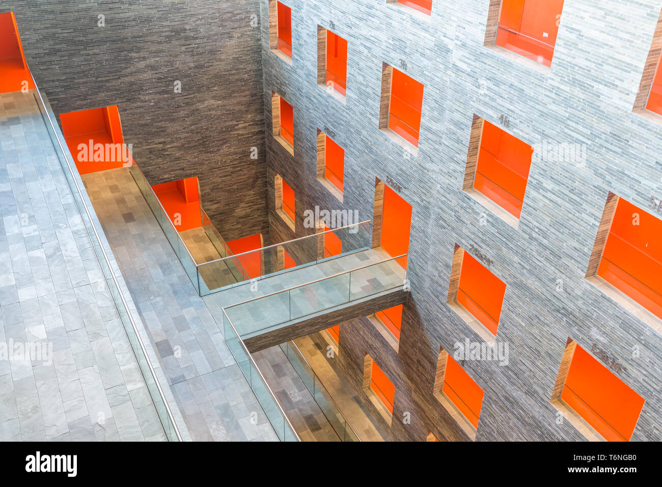 Interior modern building with several floors and orange painted ...