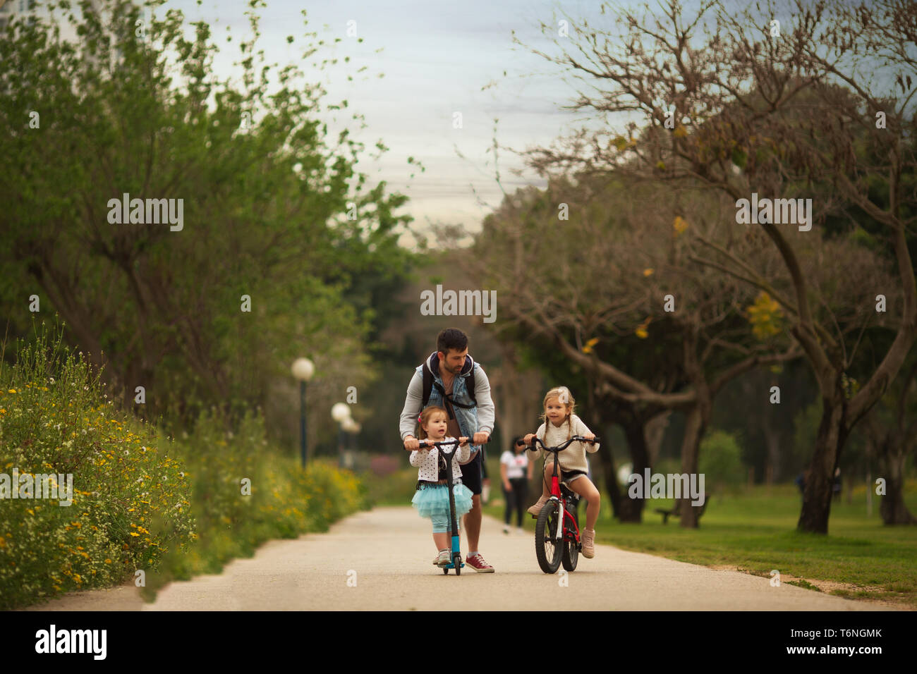 family on a morning bike ride in the Park Stock Photo - Alamy