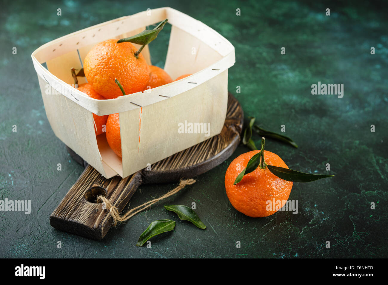 Tangerines with leaves in fruit basket hi-res stock photography and ...