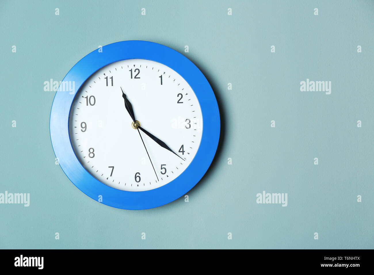 Modern clock on color wall. Time management concept Stock Photo - Alamy