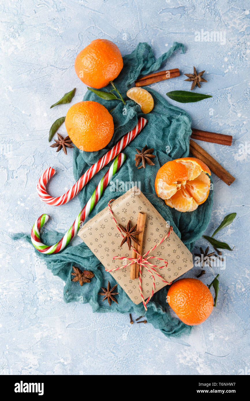 Christmas gift box, candy cane, tangerines Stock Photo - Alamy