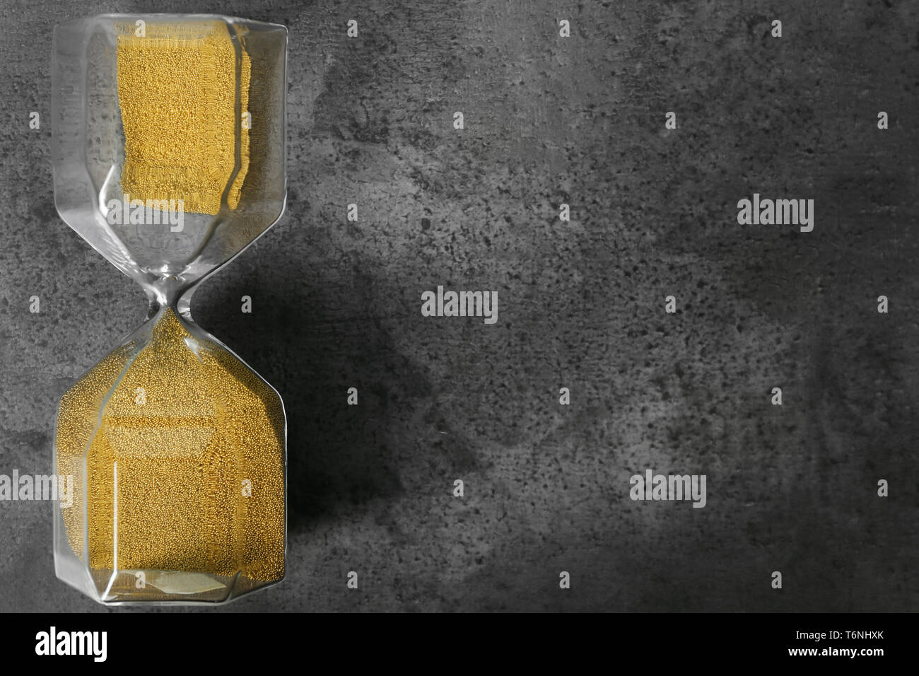 Hourglass on grey textured background. Time management concept Stock ...