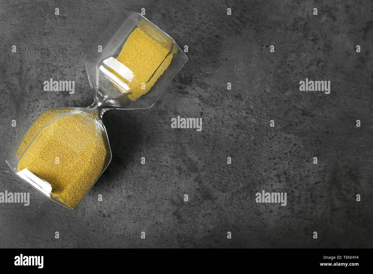 Hourglass on grey textured background. Time management concept Stock ...
