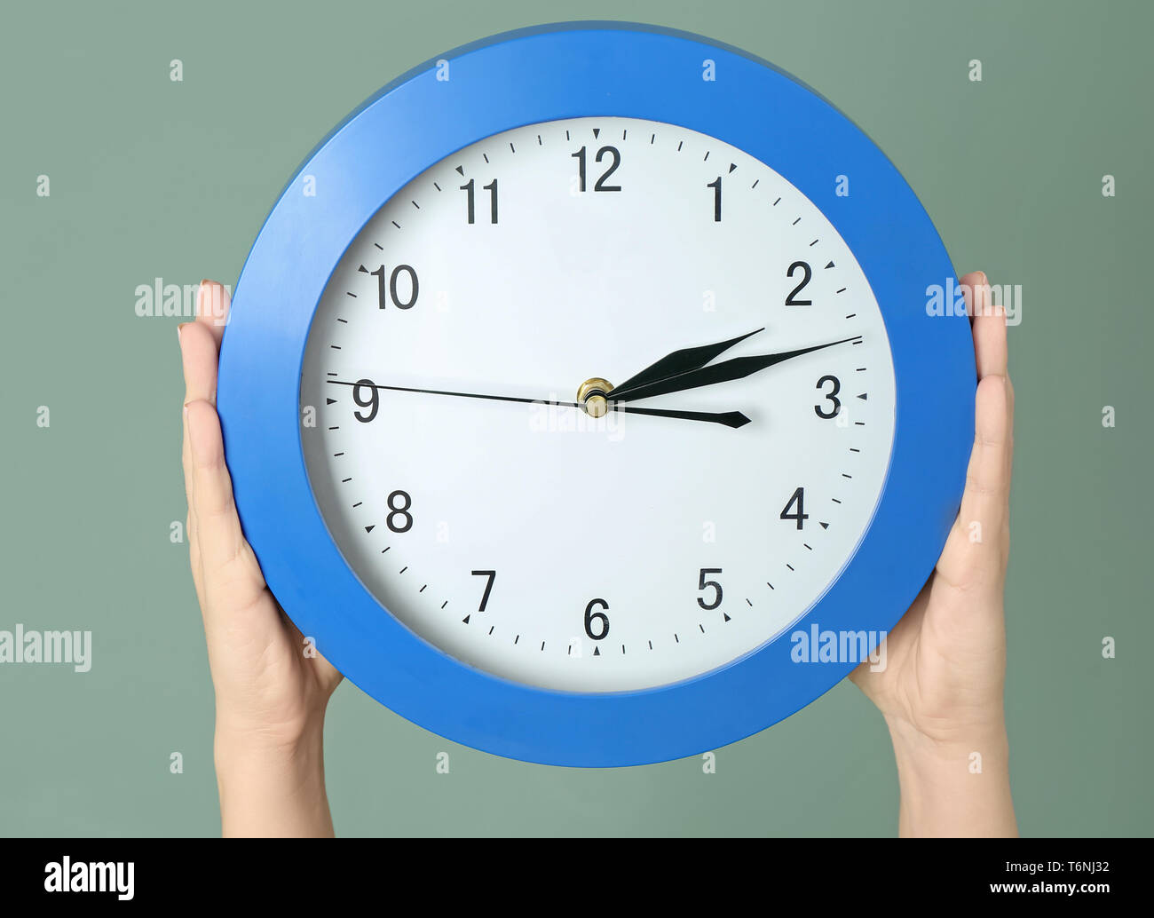Woman holding clock on color background. Time management concept Stock ...