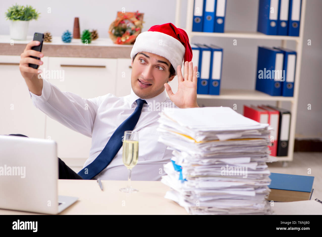 Young worker working in office on christmas shift Stock Photo - Alamy