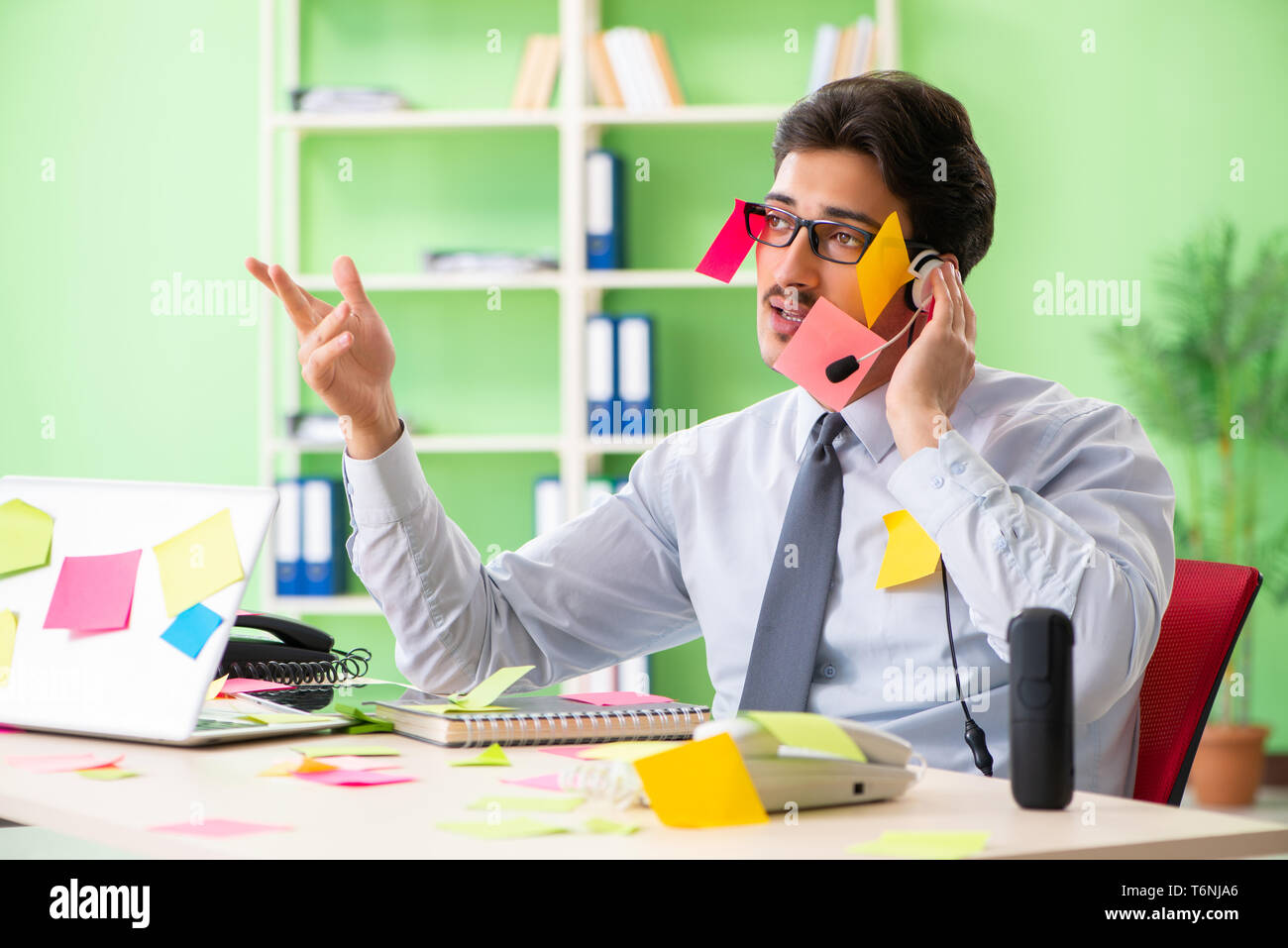 Young help desk operator working in office with many conflicting Stock ...