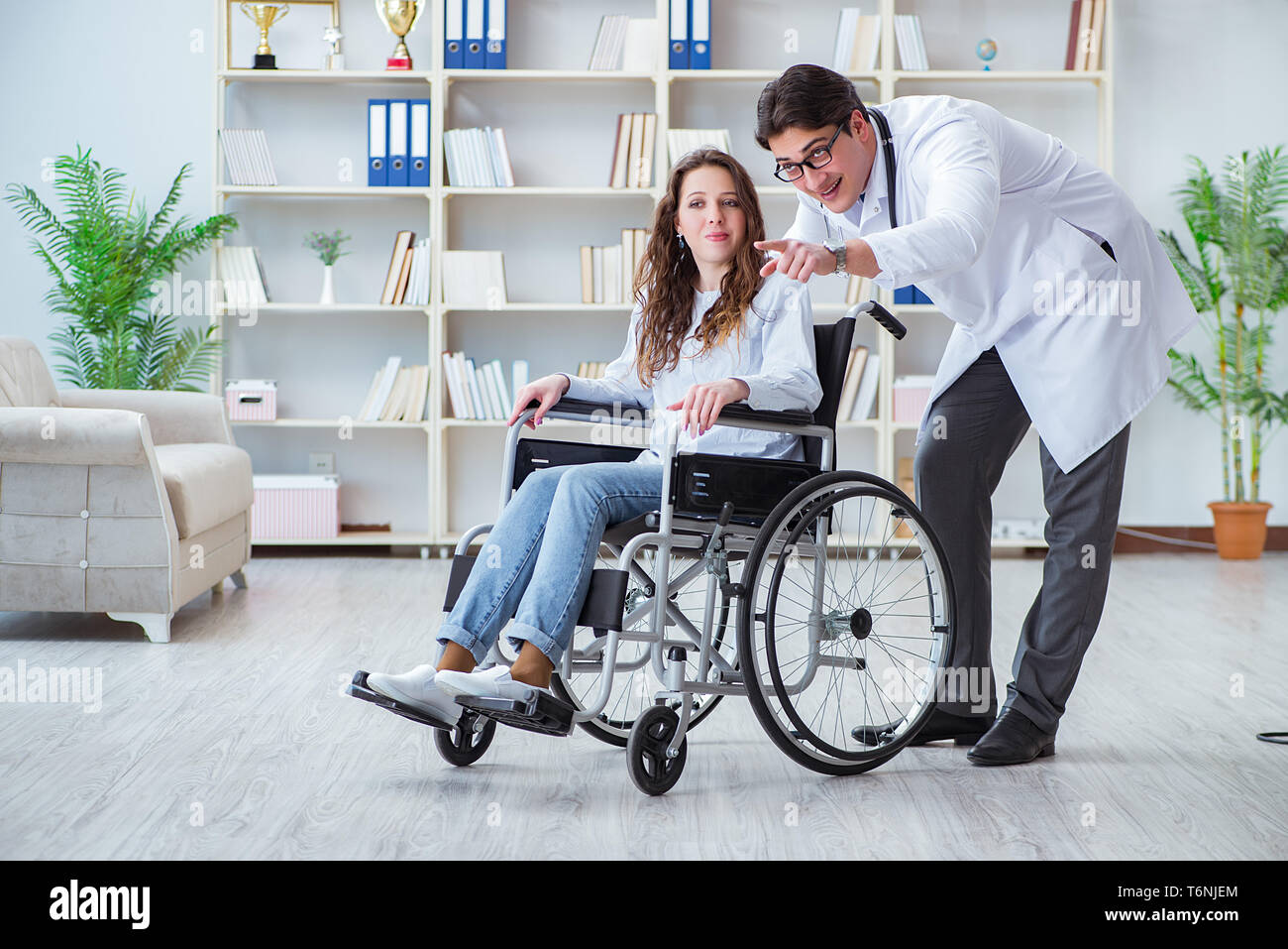 Disabled patient on wheelchair visiting doctor for regular check Stock ...