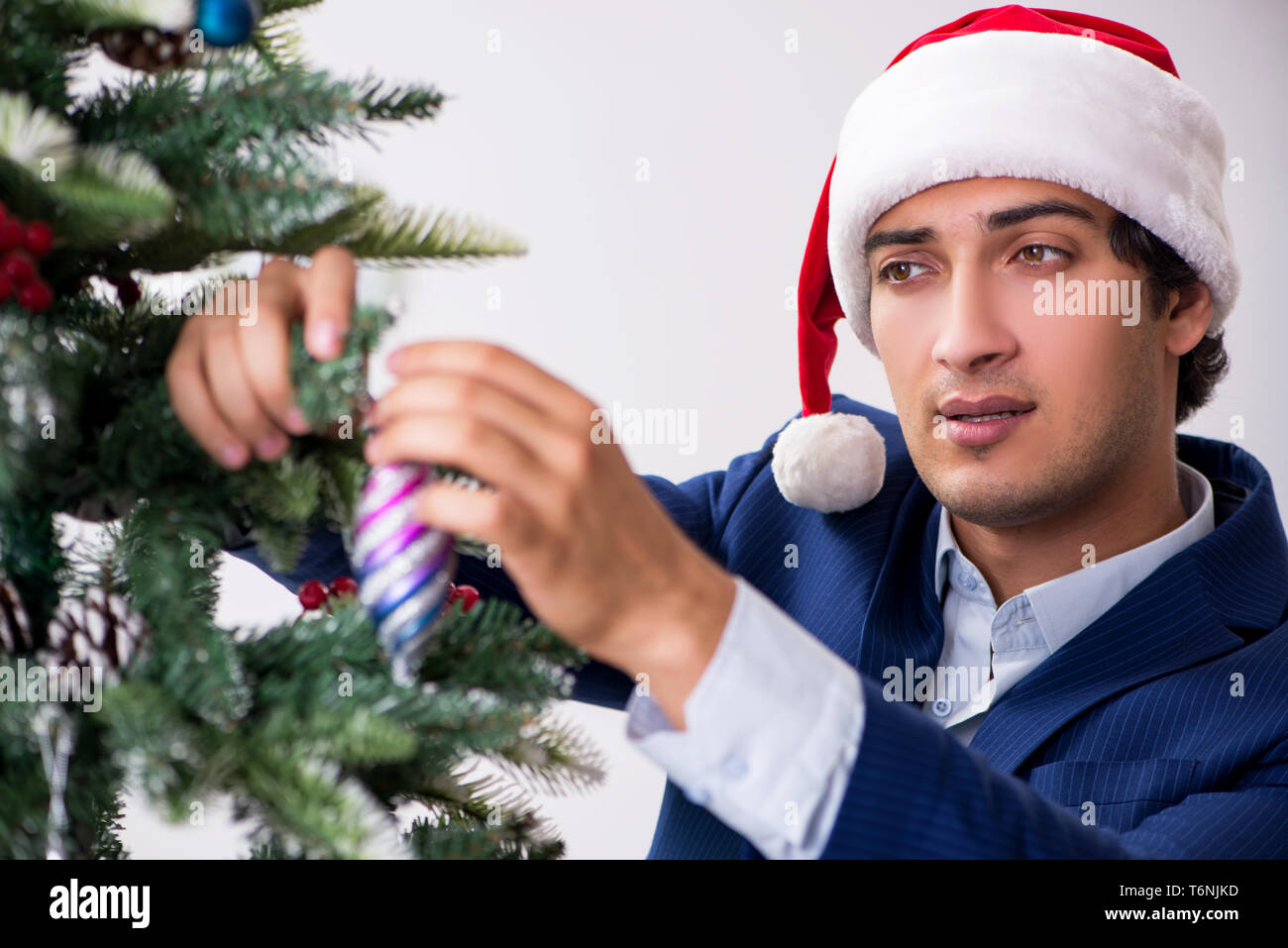 Young employee celebrating christmas at workplace Stock Photo - Alamy