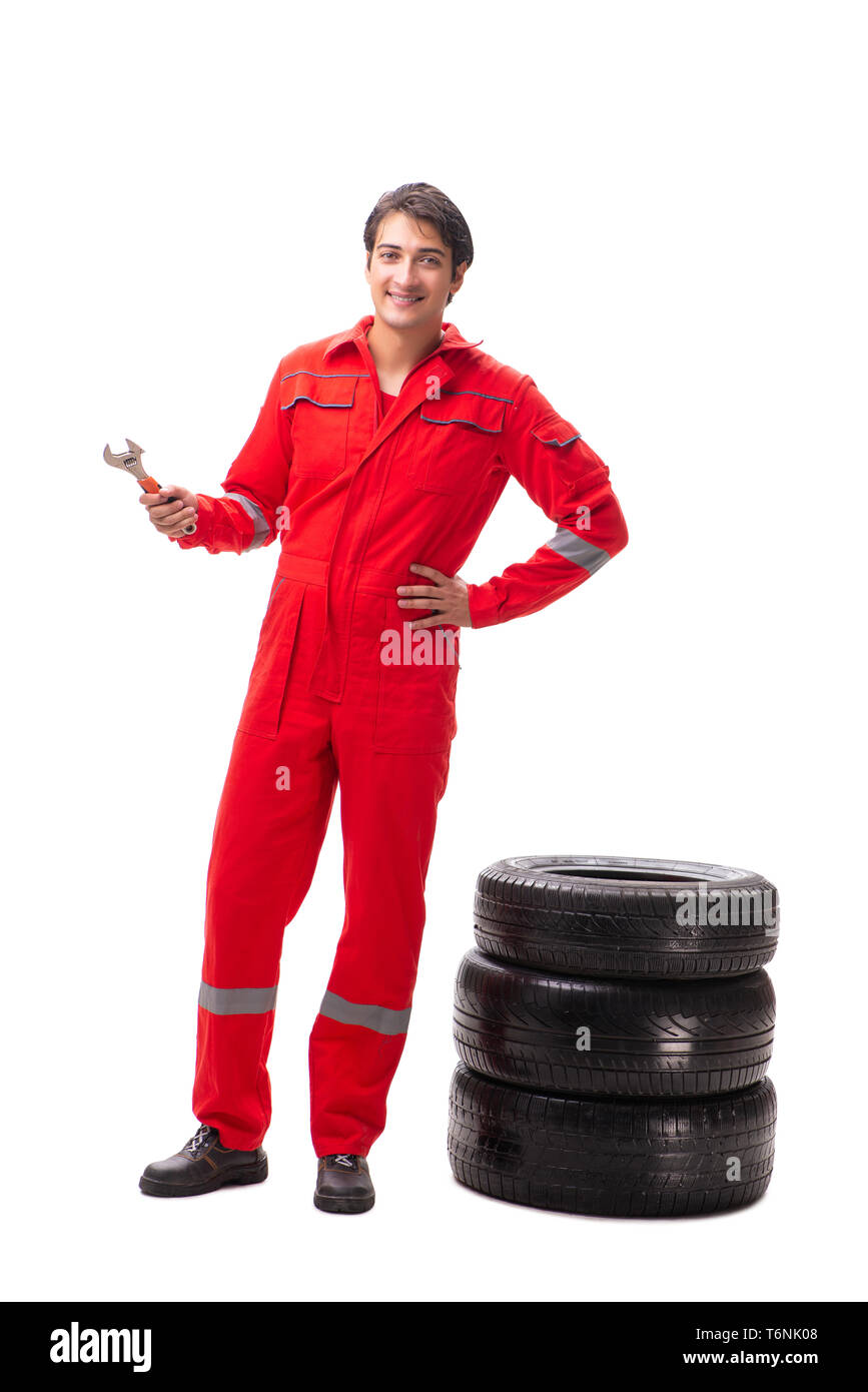 Young garage worker with tyre isolated on white Stock Photo - Alamy