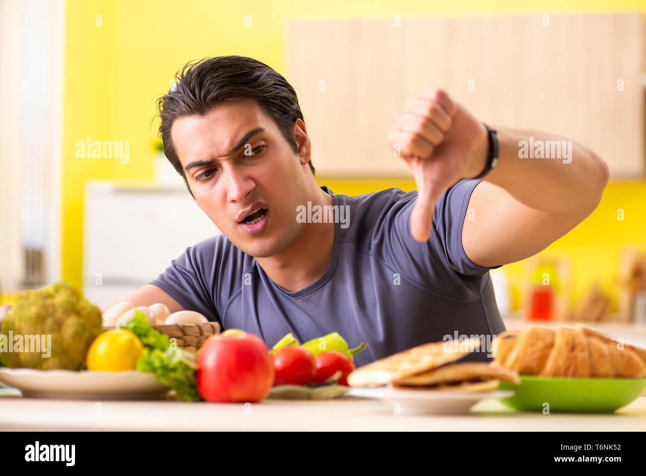 Man having hard choice between healthy and unhealthy food Stock Photo ...