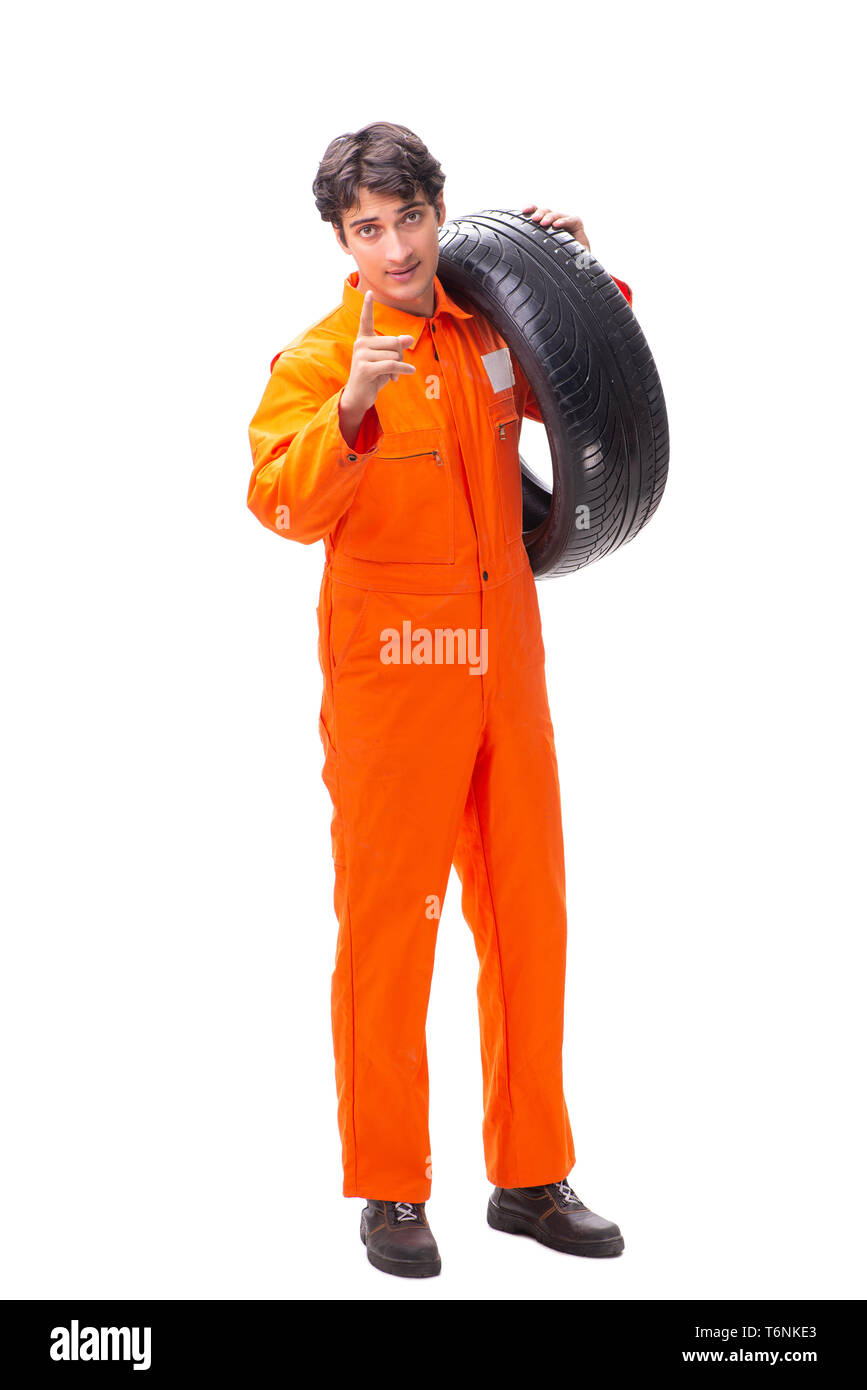 Young garage worker with tyre isolated on white Stock Photo - Alamy