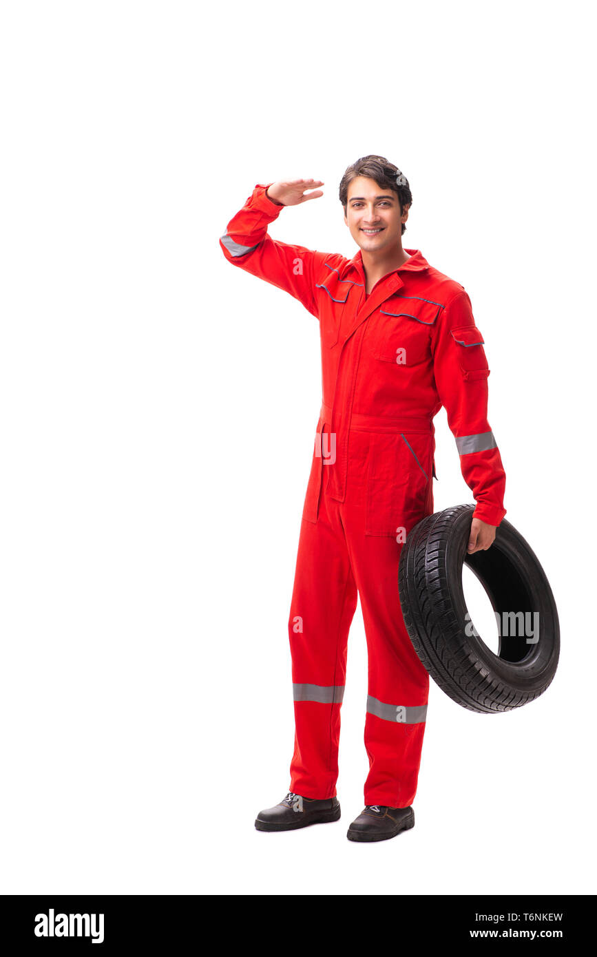 Young garage worker with tyre isolated on white Stock Photo - Alamy