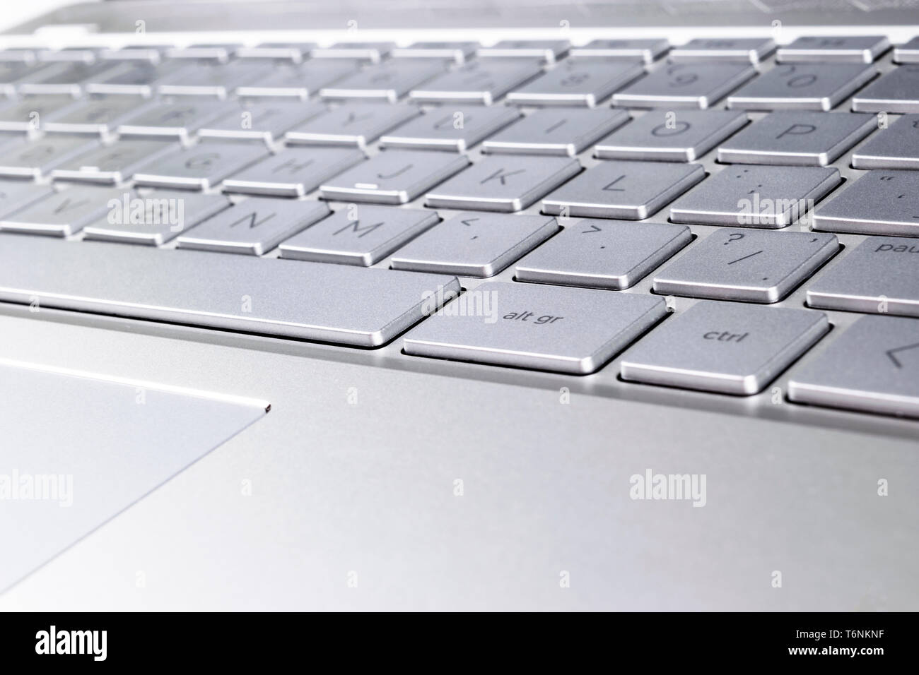 Closeup of a modern silver laptop computer keyboard. Laptop keyboard ...