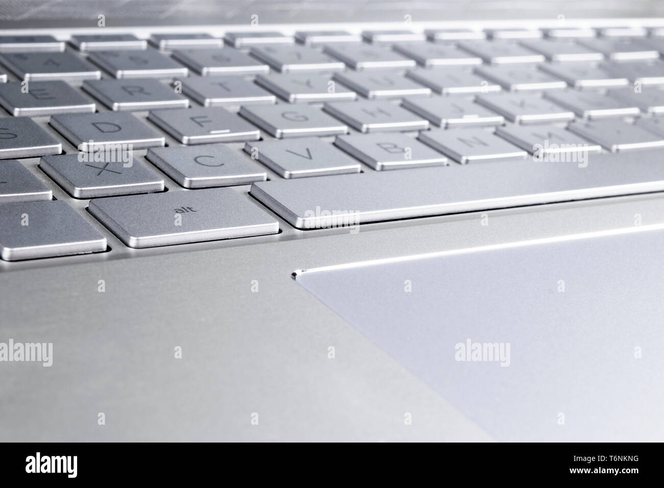 Closeup of a modern silver laptop computer keyboard. Laptop keyboard ...