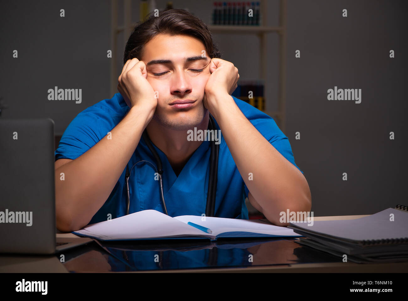 Young handsome doctor working night shift in hospital Stock Photo - Alamy