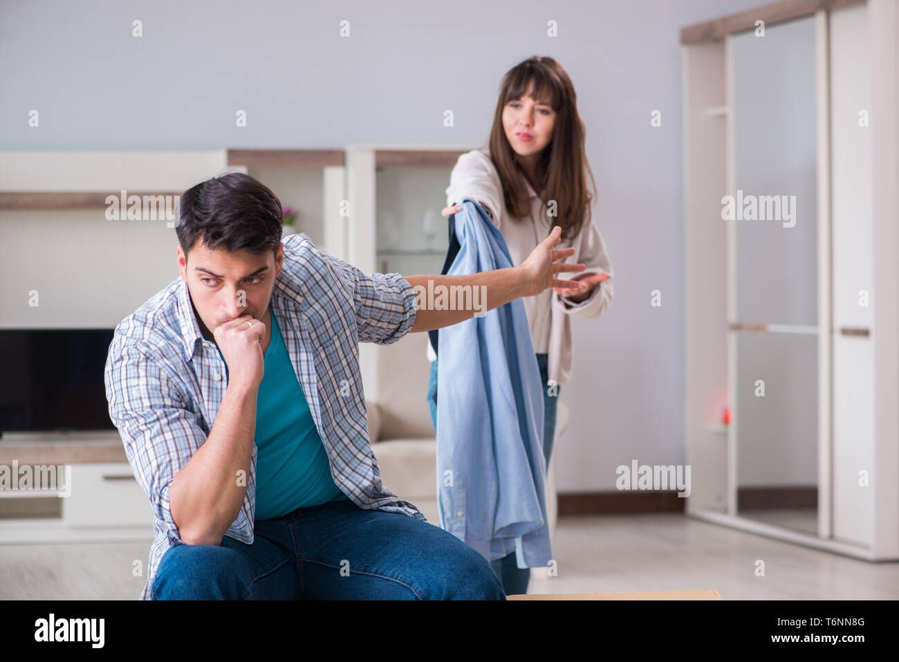 The woman evicting man from house during family conflict Stock Photo ...