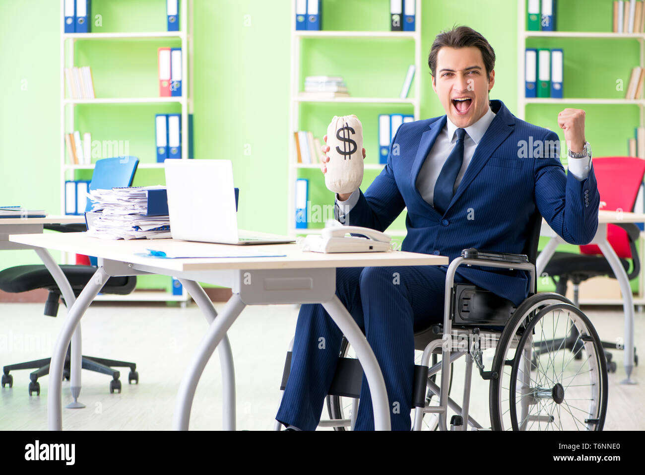 The disabled businessman working in the office Stock Photo - Alamy