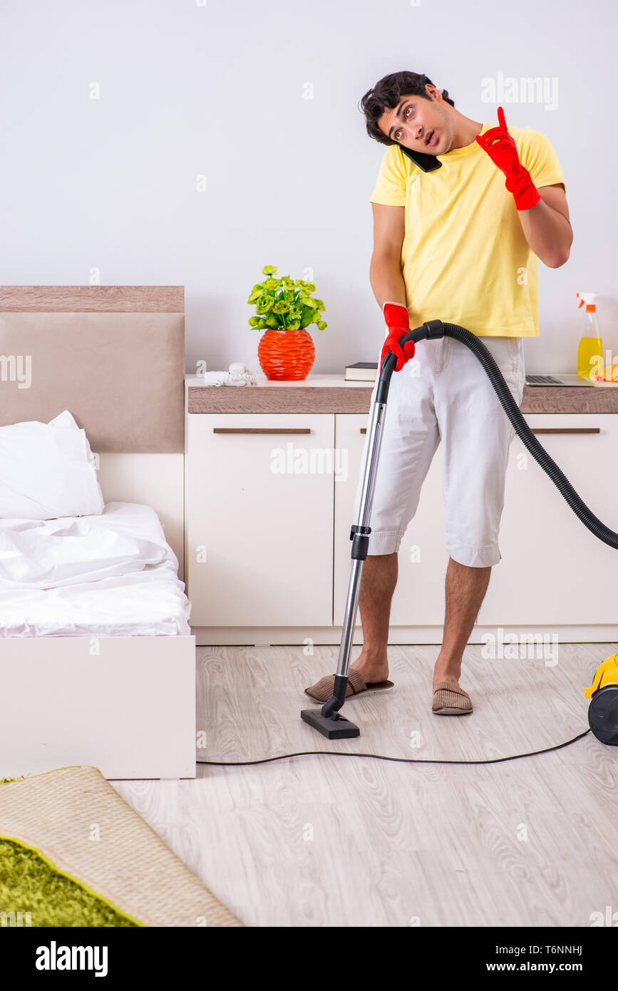 Man vacuuming bed hi-res stock photography and images - Alamy